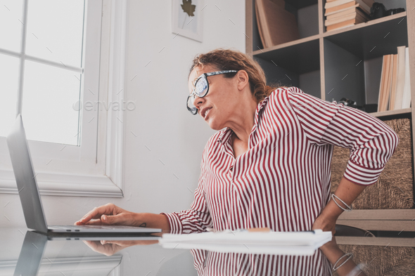 Close up rear view stressed young woman touching lower back feeling ...