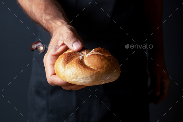 The bread baker gives a roll Stock Photo by Pasanheco | PhotoDune