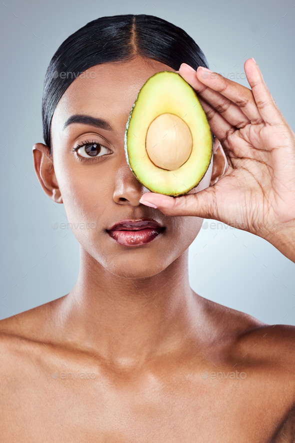 Cropped portrait of an attractive young woman posing in studio against ...