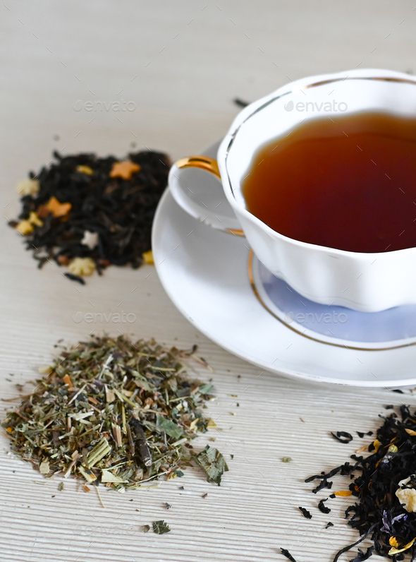 A set of different types tea next to the kettle filled with hot brewed ...