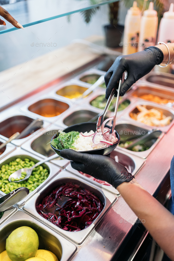 Woman Adding Ingredients Into Poke Bowl Stock Photo by nunezimage ...