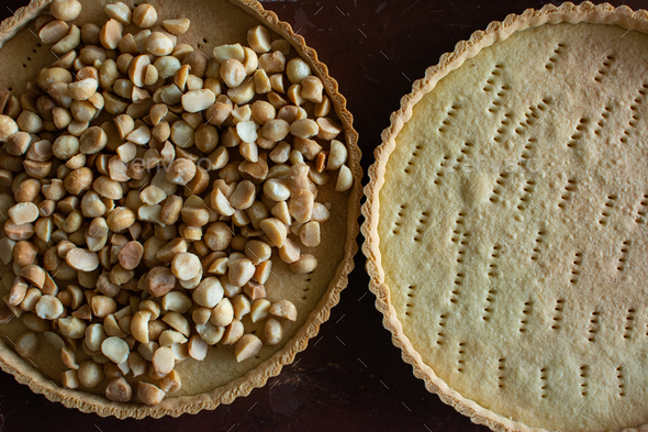 Filling the macadamias cake with toffee and chocolate. Preparing mix ...