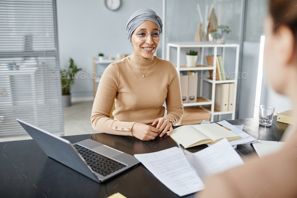 Muslim Young Woman in Job interview Stock Photo by seventyfourimages