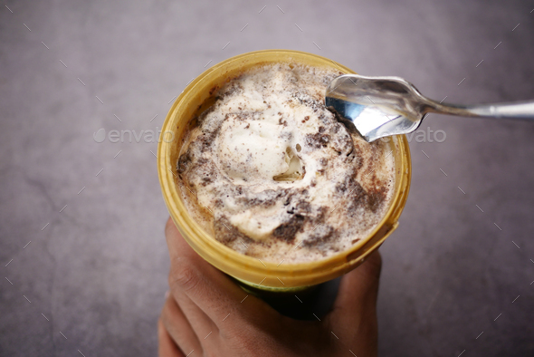 young men eating vanila flavor ice cream in a container Stock Photo by ...