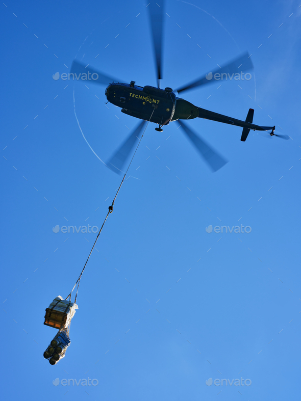Bottom view of a flying helicopter with cargo suspended on a rope Stock ...