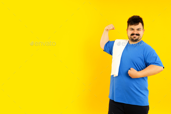Concept of people, young fat man on yellow background Stock Photo by ...