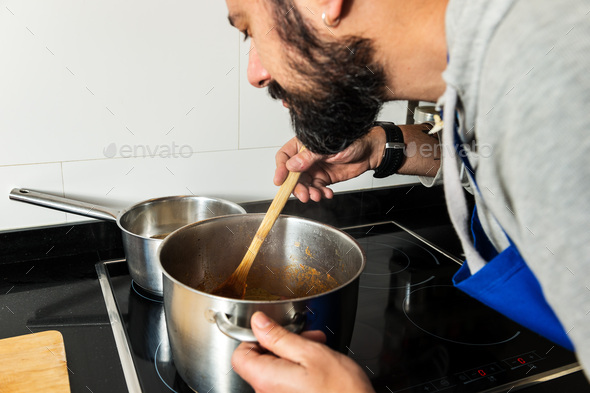 amateur cook smell the food being prepared Stock Photo by Raul_Mellado