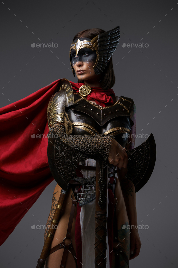 Ancient woman barbarian dressed in red cloak holding axe Stock Photo by fxquadro