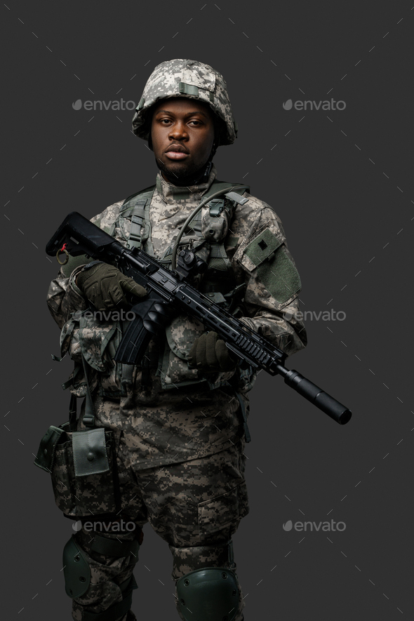Armed black soldier with rifle looking at camera Stock Photo by fxquadro