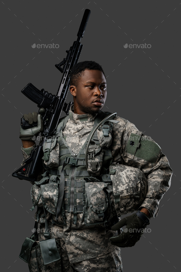 Courageous black soldier holding rifle on his shoulder Stock Photo by ...