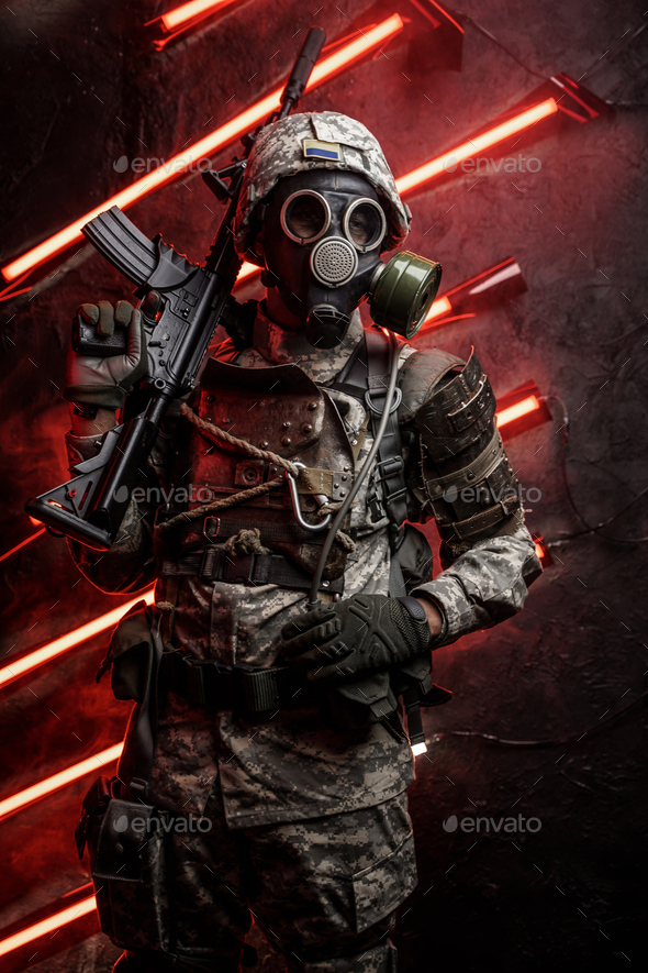 Soldier with gas mask holding rifle on his shoulder Stock Photo by fxquadro