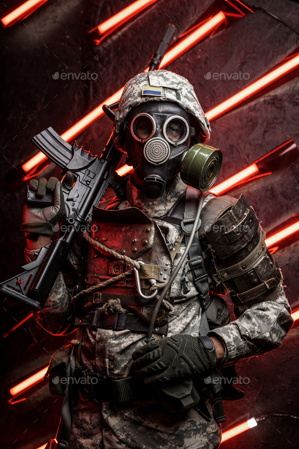 Soldier with gas mask holding rifle on his shoulder Stock Photo by fxquadro