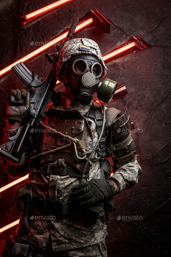 Soldier with gas mask holding rifle on his shoulder Stock Photo by fxquadro