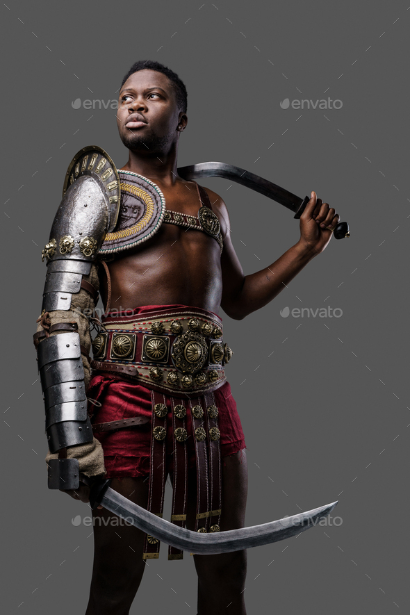 Black gladiator dressed in armor wielding dual swords Stock Photo by ...
