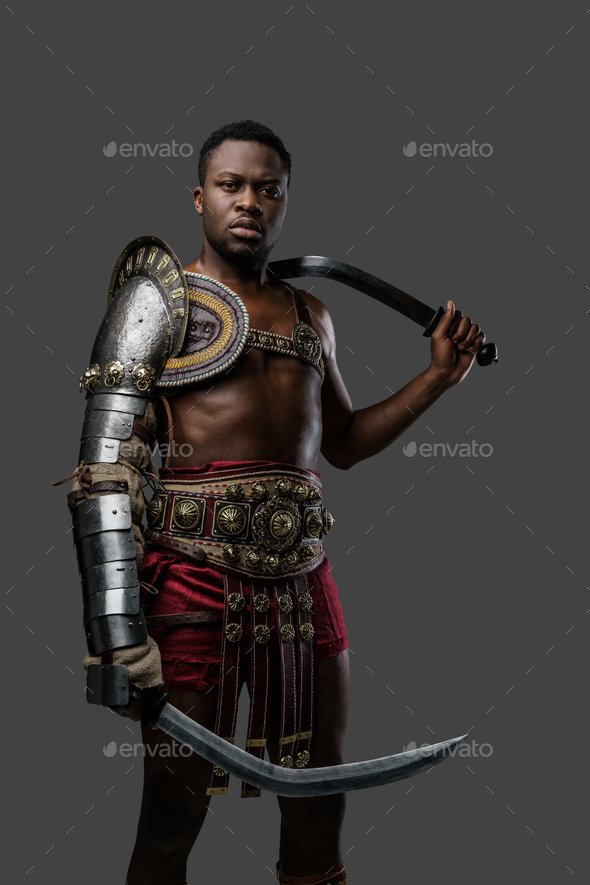 Black gladiator dressed in armor wielding dual swords Stock Photo by ...