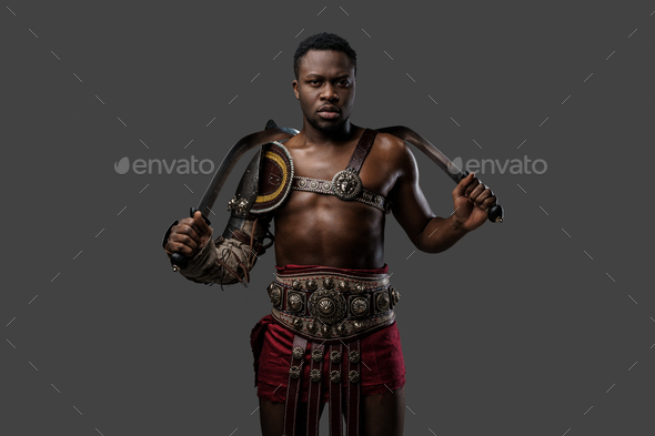 Black gladiator dressed in armor wielding dual swords Stock Photo by ...