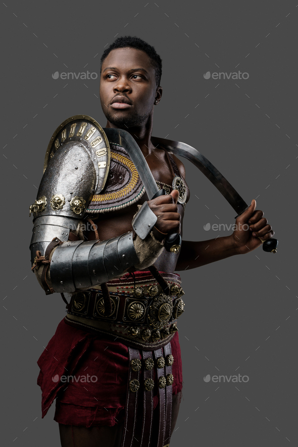African roman gladiator with twin swords isolated on gray Stock Photo ...