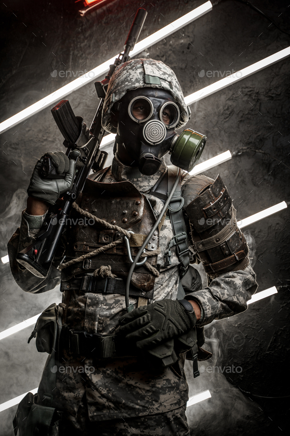 Military man with gas mask holding rifle on his shoulder Stock Photo by ...