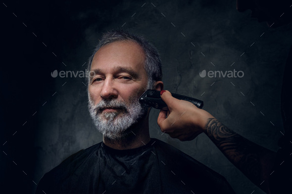 Stylish old man being cutting by woman using electric razor Stock Photo ...