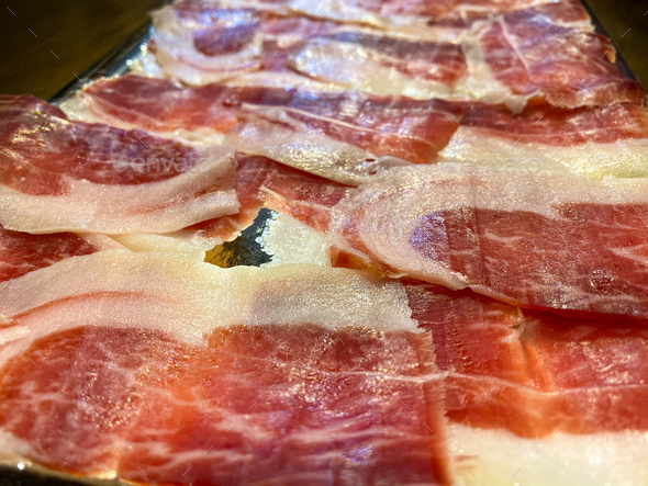 Slices spanish dried pork also known as Jamon Serrano. Typical tapa ...