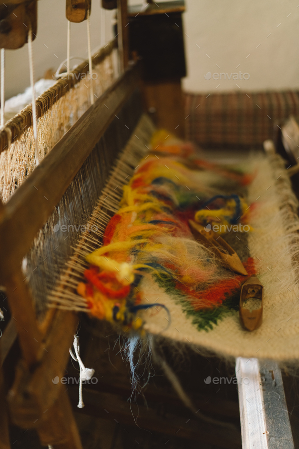 Old wooden hand loom. Ancient weaving loom in interior of wooden log ...