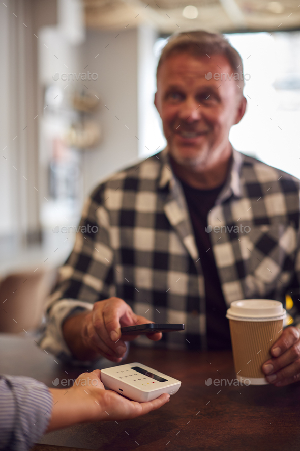 Male Customer Making Contactless Payment In Coffee Shop Using Mobile ...