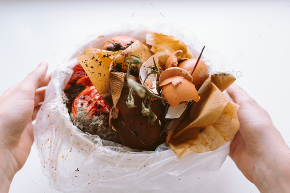 Bucket with biological garbage, food waste in biodegradable package ...