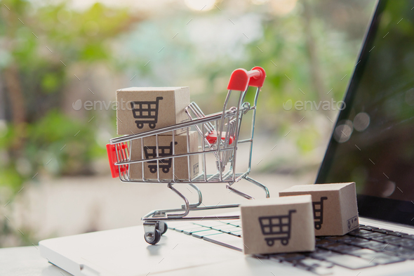Shopping online. Cardboard box with a shopping cart logo in a trolley ...