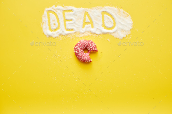 Half-eaten doughnut and dead word written on sugar Stock Photo by Media ...