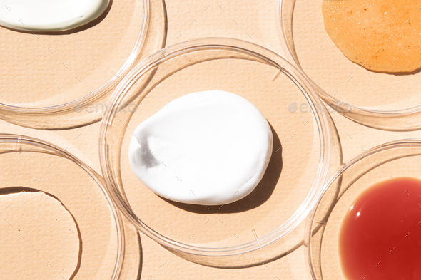 Smears of different cosmetic textures in glass containers close-up ...