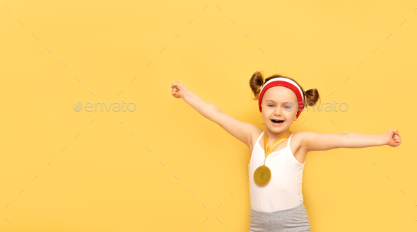 Sport success and win concept child girl celebrates first place victory ...