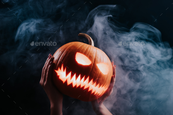 Steaming pumpkin laughing evilly - head of jack-o-lantern with carved ...