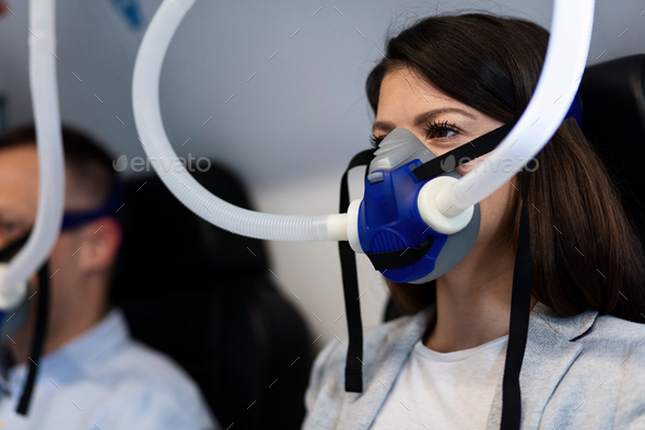 Female patient wearing oxygen mask during hyperbaric oxygen therapy ...