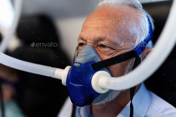 Mature man breathing through oxygen mask in hyperbaric chamber. Stock ...