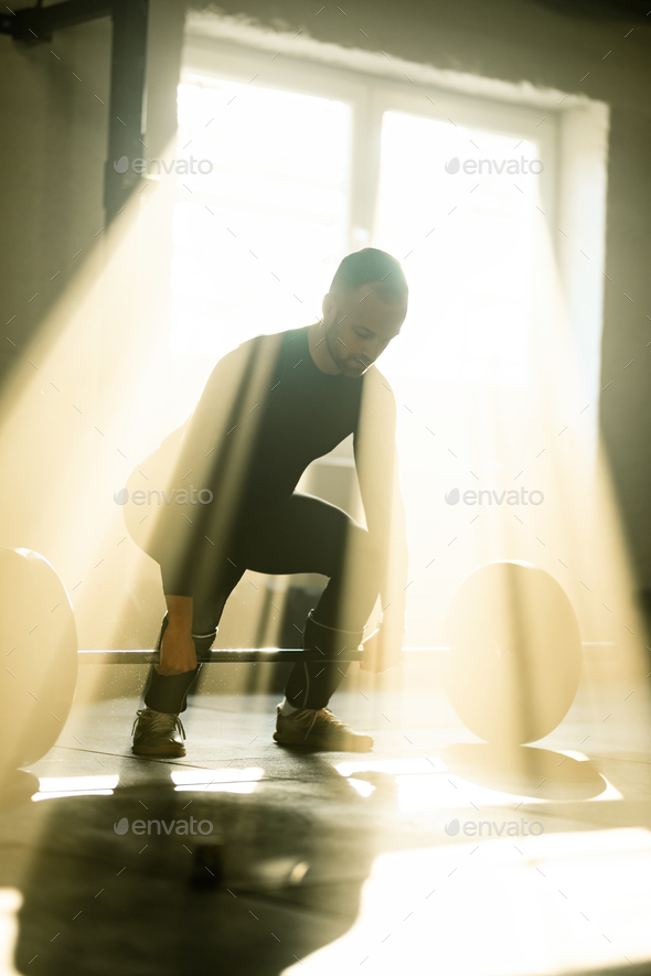 Young muscular build man exercising deadlift in a gym. Stock Photo by ...