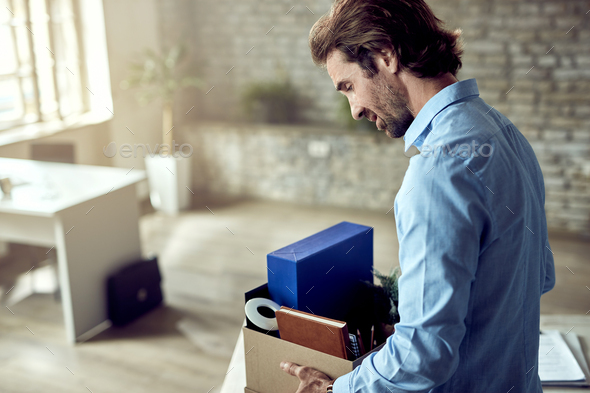 Young sad businessman leaving the office after getting fired. Stock ...