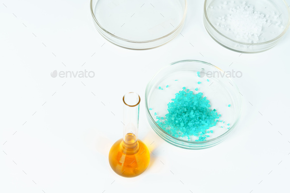 Colored liquids inside lab glassware on white table in laboratory Stock ...