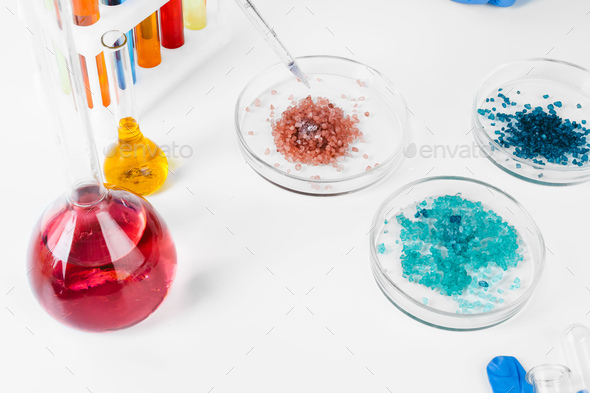 Colored liquids inside lab glassware on white table in laboratory Stock ...