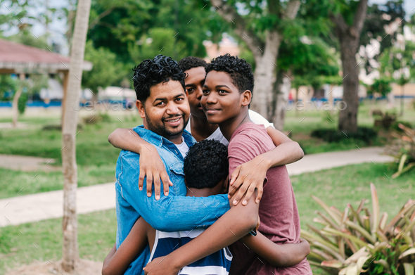 Dominican man celebrating father's day with his children in the park ...