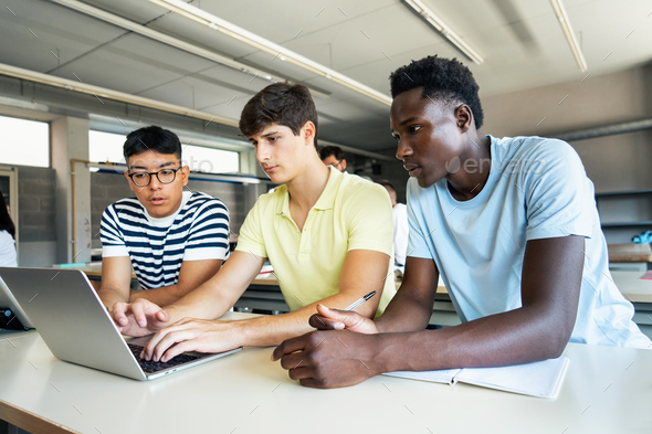 Teenager students working together at High School Classroom, doing ...