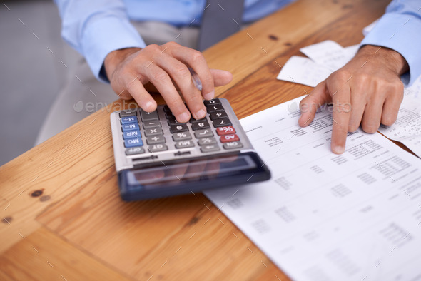 Double-checking the numbers. Cropped shot of a businessman using a ...