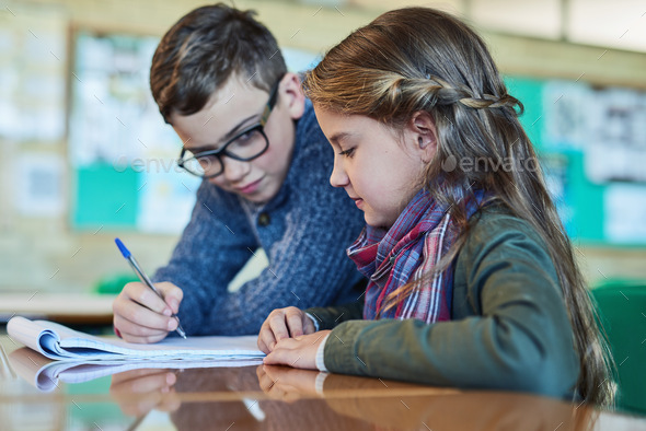 Shot of two elementary school kids working together in class Stock ...