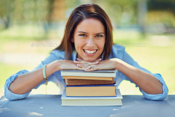 Portrait of a beautiful young college student resting her head on a ...