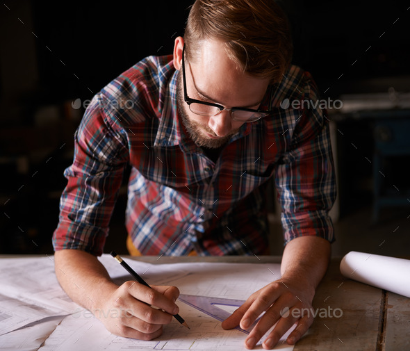 Turning his vision into reality. An architect drawing up plans. Stock ...