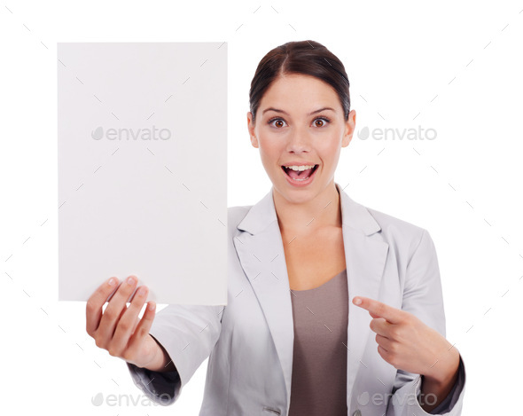 Shot of a young women pointing at a small blank sign she is holding ...