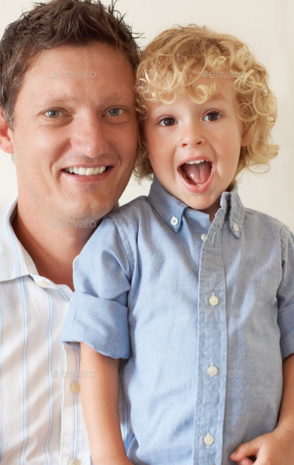Faces full of fun. Portrait of a smiling father and toddler son. Stock ...