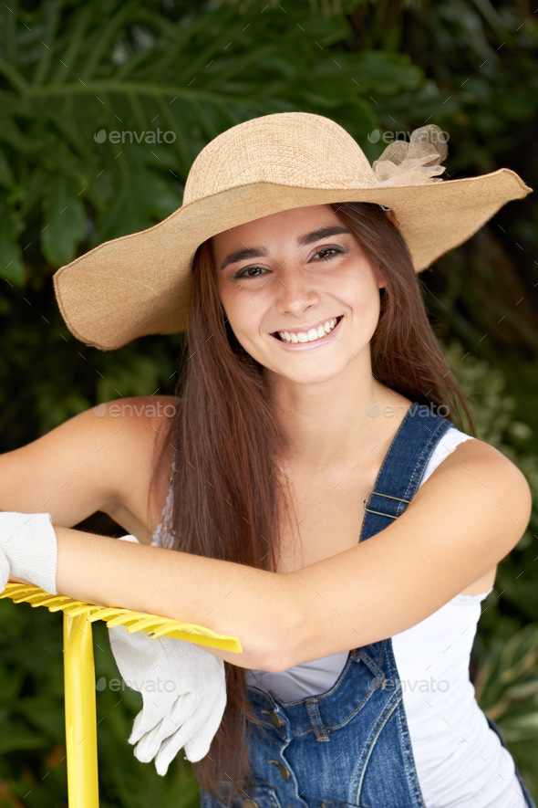 Keeping her garden tidy. Portrait of an attractive young woman leaning ...