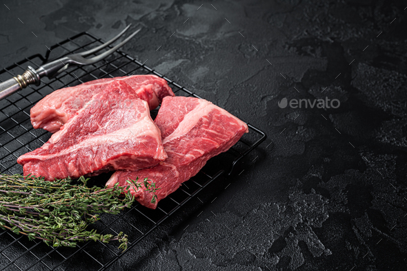 Topside sirloin beef cut, raw meat with spices. Black background. Top ...
