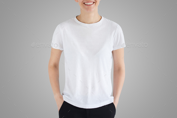 Young woman standing with hands in pockets, wearing blank white t-shirt ...