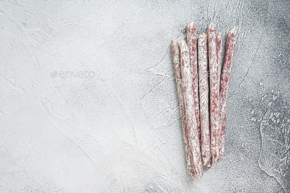 Traditional Spanish mini fuet sausage. White background. Top view. Copy ...